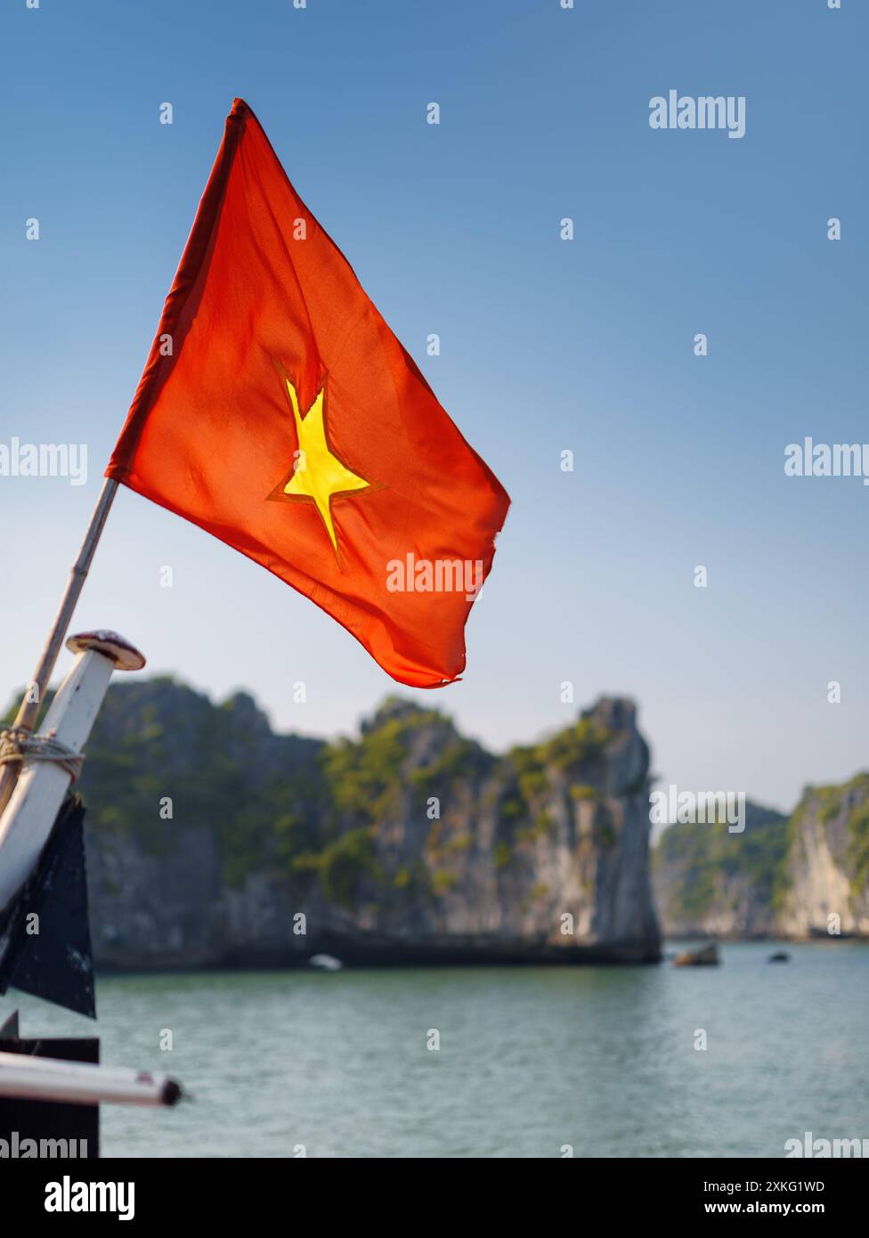 The flag of Vietnam on blue sky background, the Ha Long Bay Stock Photo ...