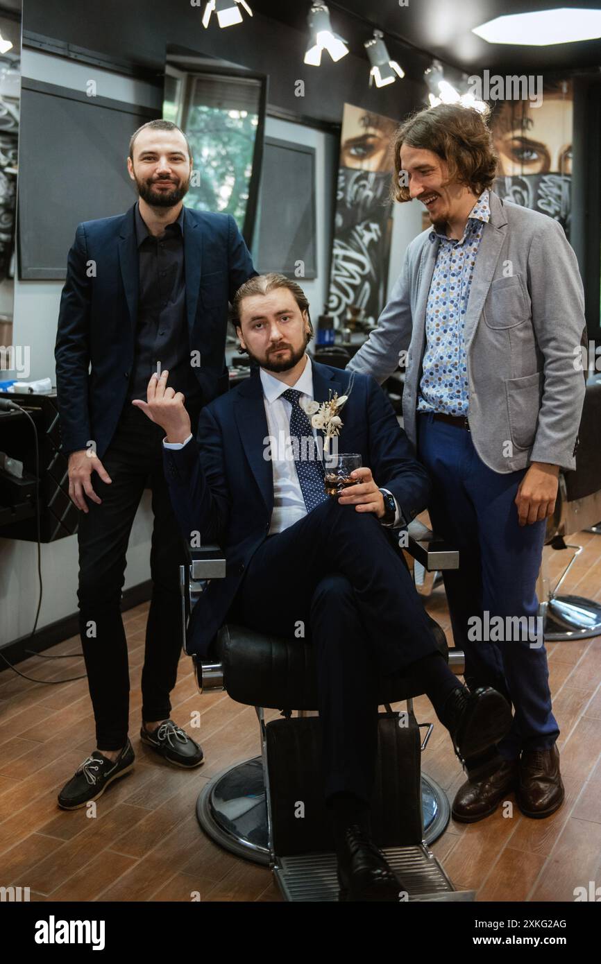 portrait of a male groom in a blue suit in the morning going to the ...