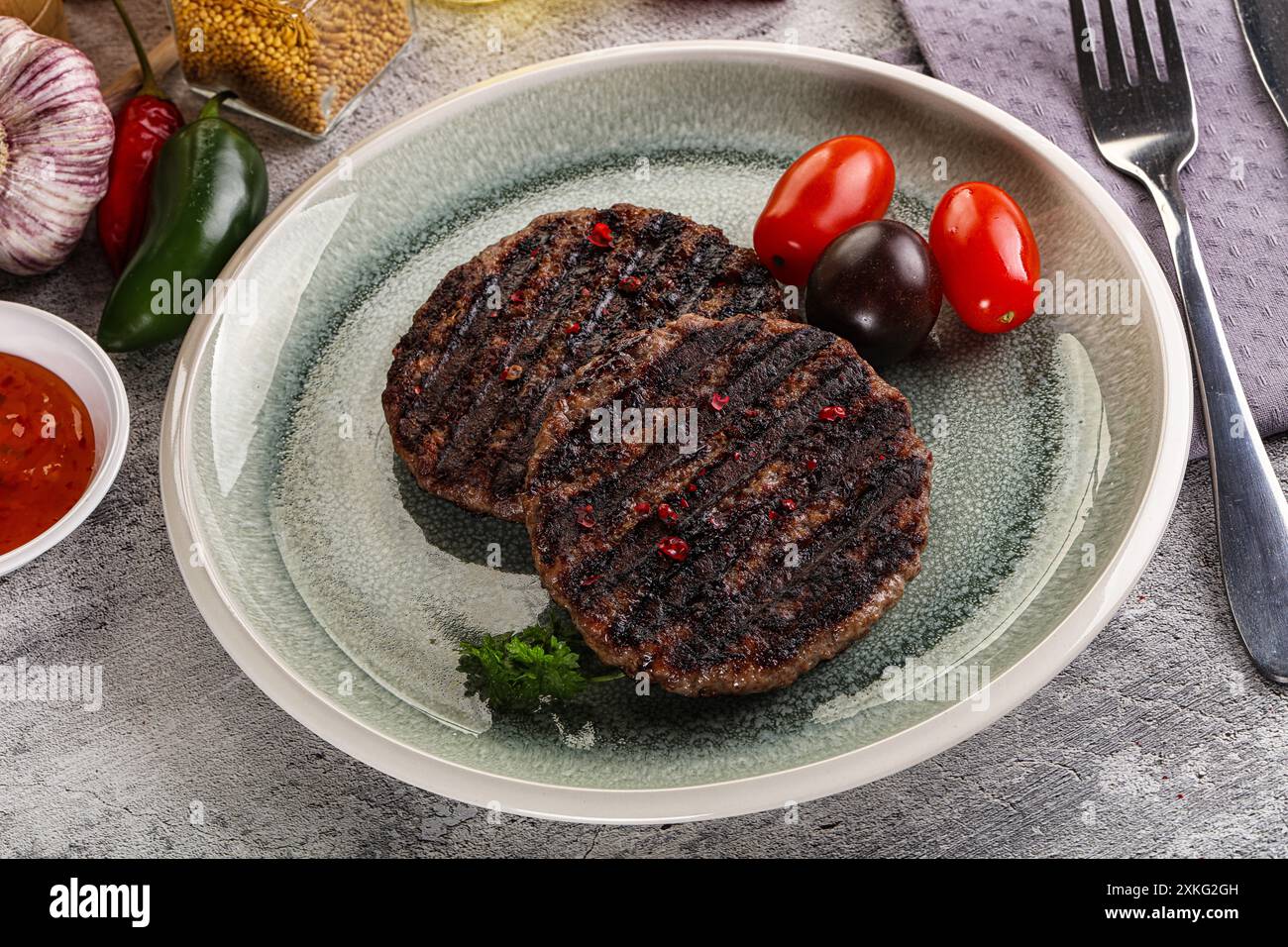 Grilled beef burger cutlet with sauce Stock Photo - Alamy