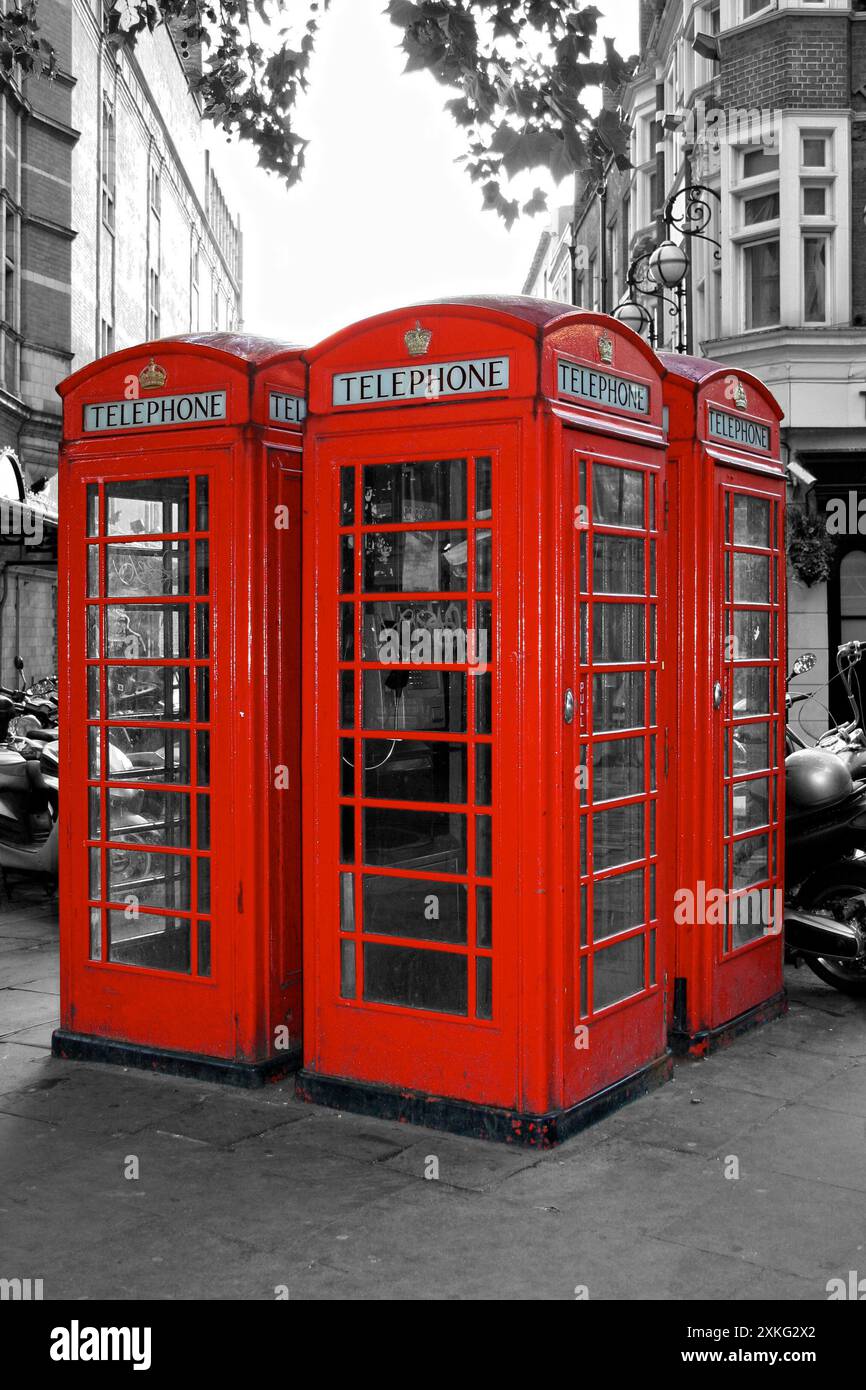 Four traditionnal red british phone booth in a street of London, UK ...