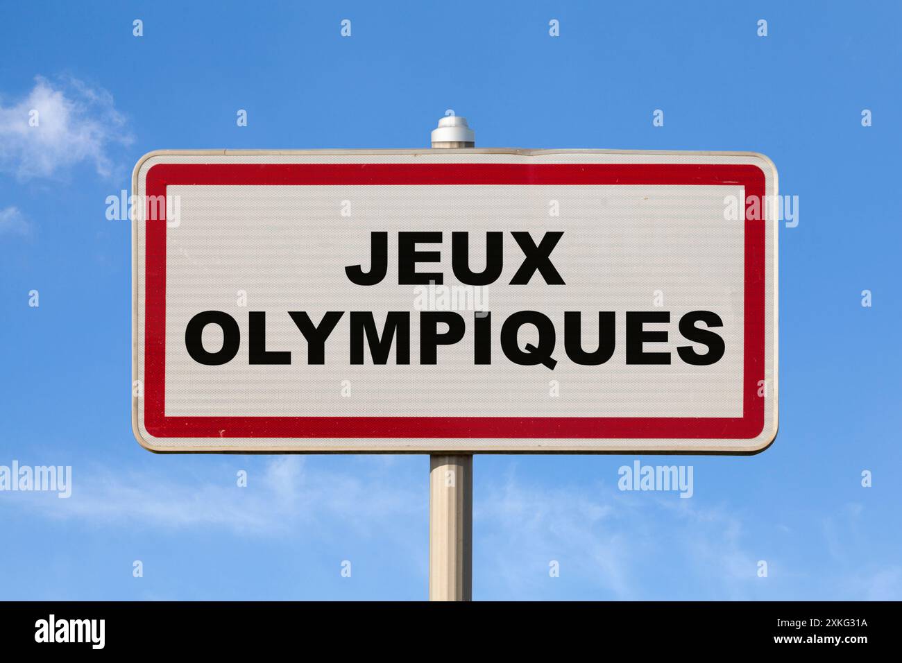 A French entry city sign against a blue sky with written in the middle ...