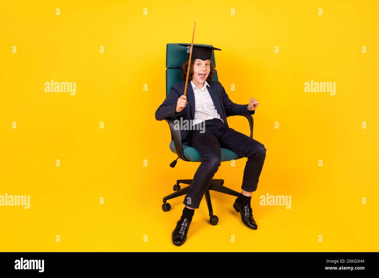 Full length photo of small schoolboy sit armchair hold stick pointer ...