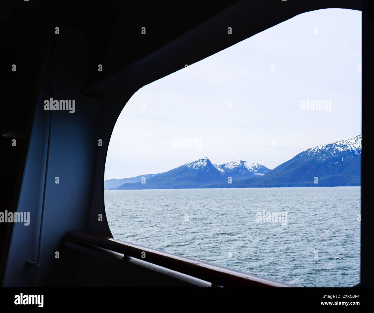 View of snow-capped mountains from the deck of a cruise ship window. Alaska Stock Photo - Alamy