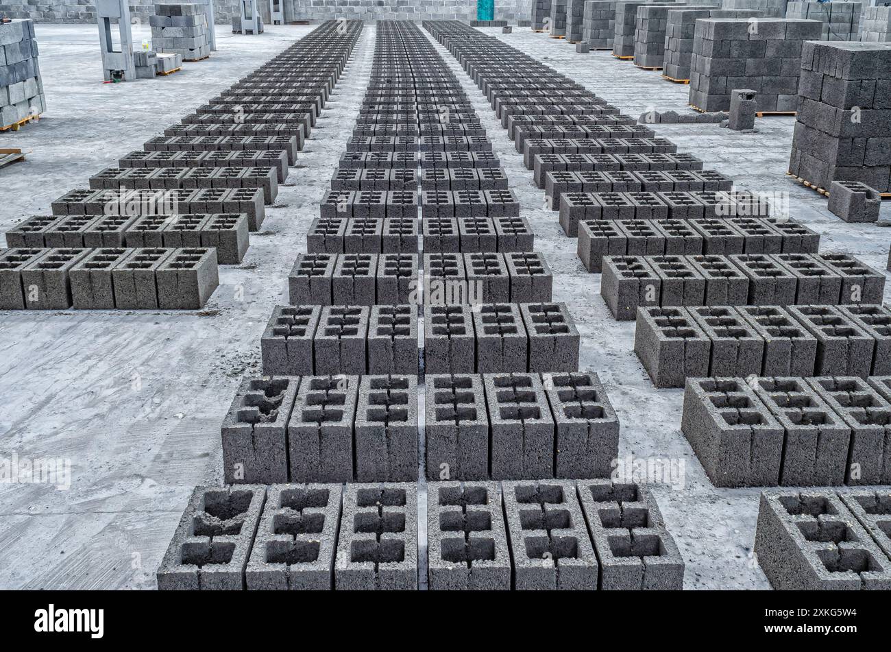 Rows of concrete cinder blocks, building material in form of gray ...
