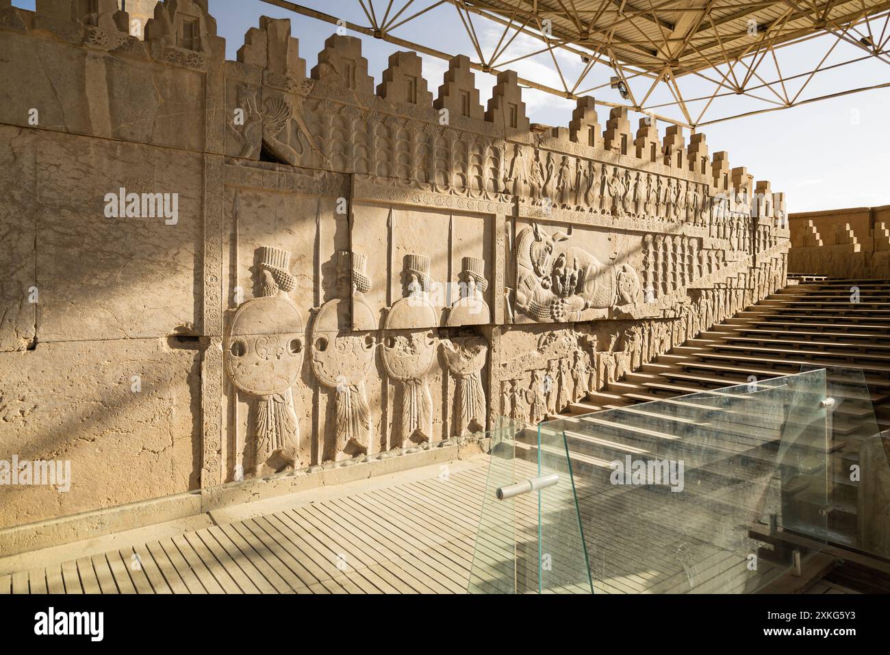 Relief carvings of embossed soldiers beside a lion hunting a bull on ...