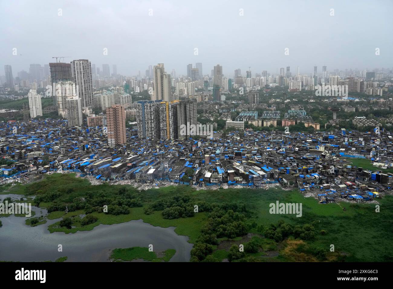 A slum and high rise buildings are seen in the background in Mumbai in ...
