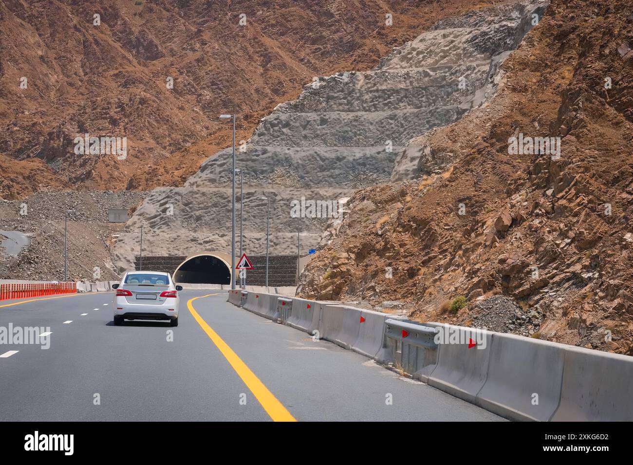 Road tunnel in mountains in Northern Emirates UAE. Entrance to deep ...
