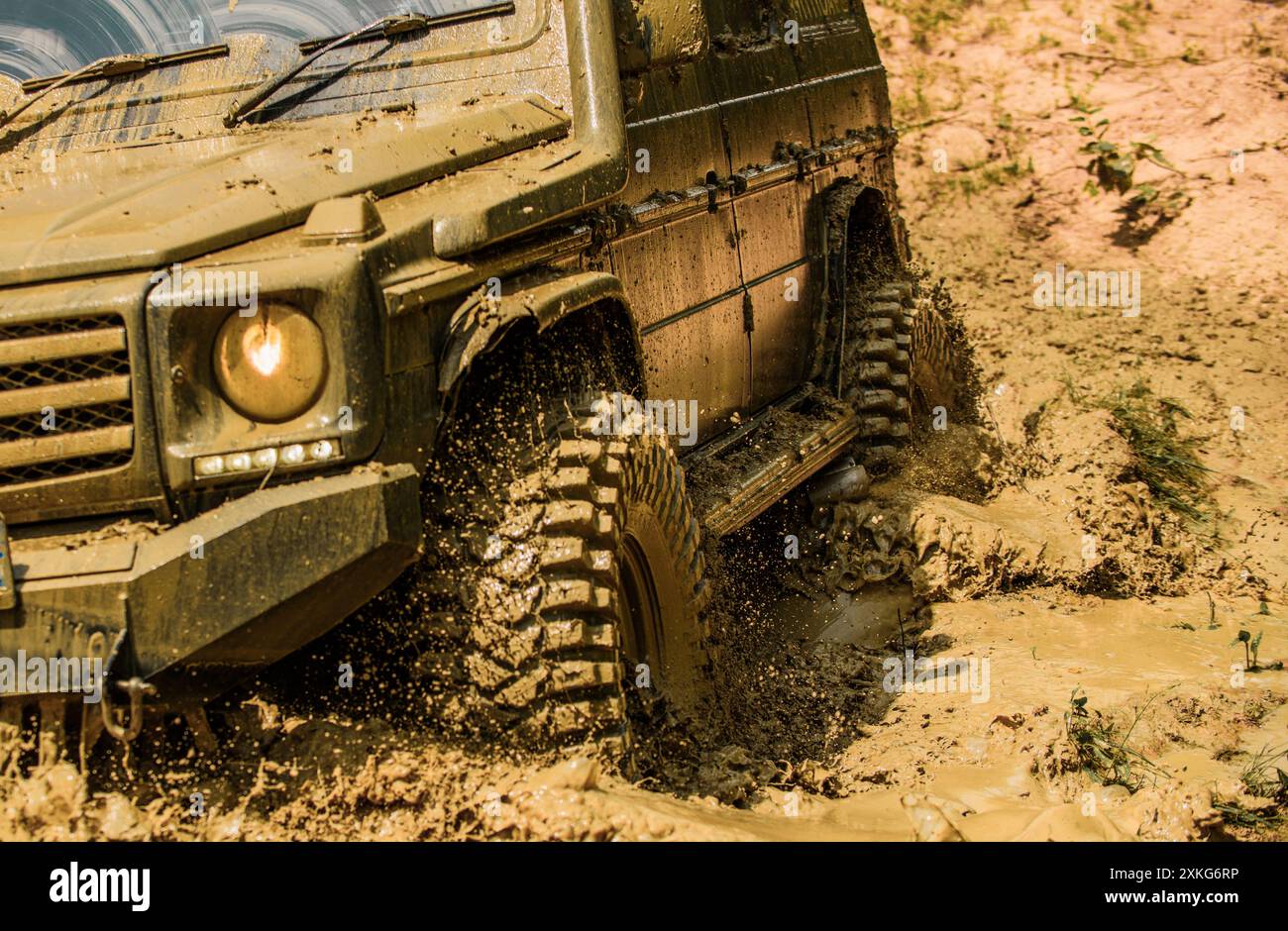 Off-road travel on mountain road. Bottom view to big offroad car wheel ...