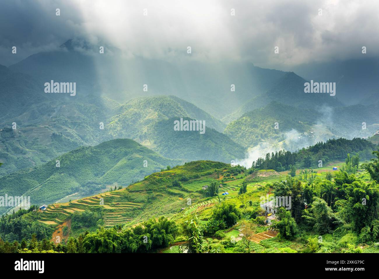 Rays of sunlight through storm clouds in mountains of Vietnam Stock ...