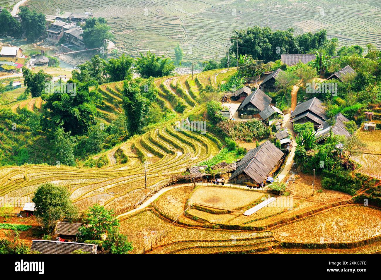 Rice terraces filled with water and roofs of village houses Stock Photo ...