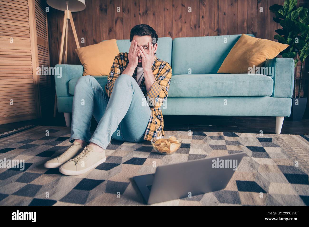 Photo of funny scared guy wear plaid shirt watching horror film modern ...