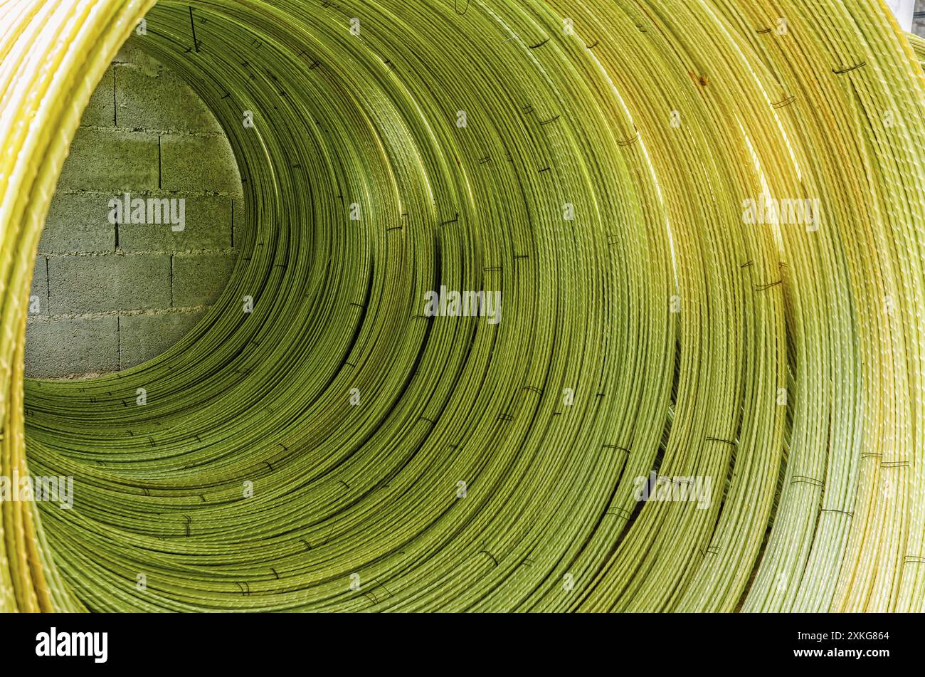 Yellow wires twisted into roll with visible details. Abstract ...