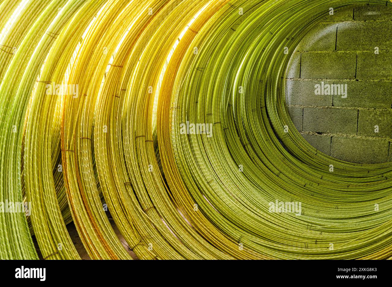 Yellow wires twisted into roll with visible details. Abstract ...