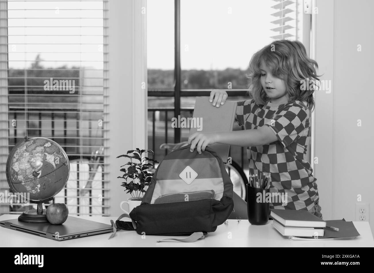 School kid student puts school supplies in a backpack. Preparation for ...