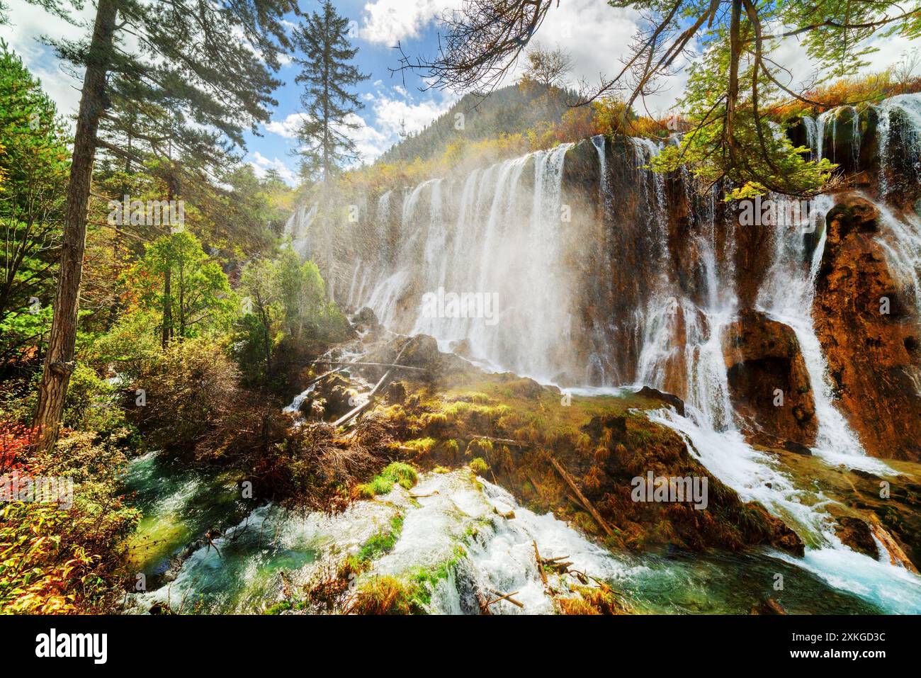 Scenic view of the Nuo Ri Lang Waterfall (Nuorilang) among woods Stock ...