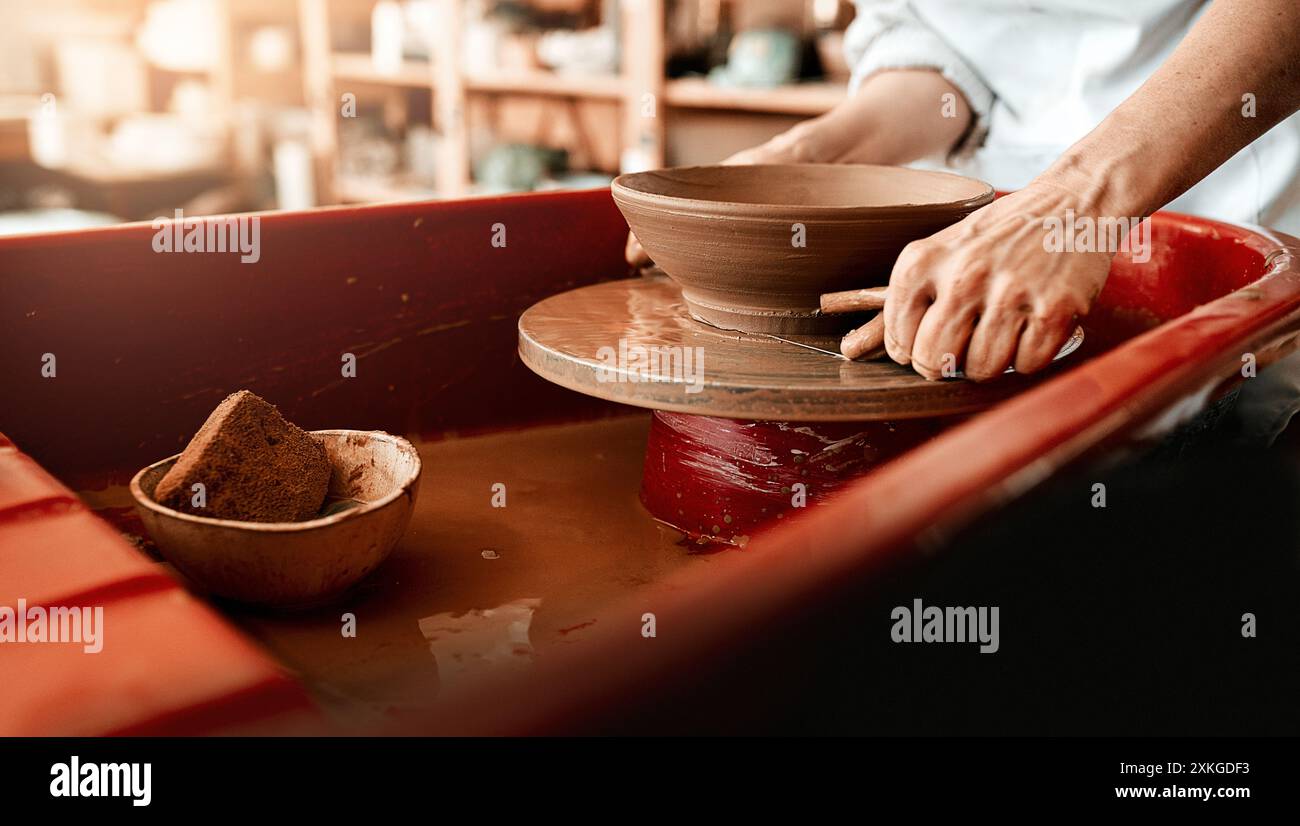 Hands, clay and wheel for pottery in workshop with craft, tools and ...