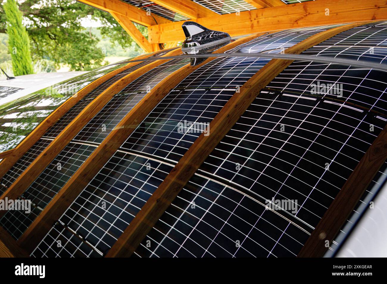 Car roof with solar panels under wooden canopy, showing renewable ...