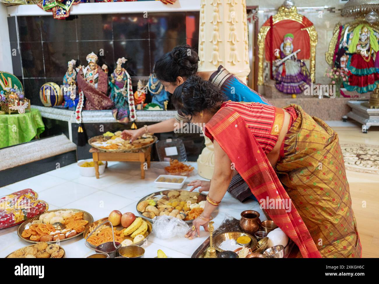 Worshippers at the Wilton Hindu temple prepare food offerings for their ...
