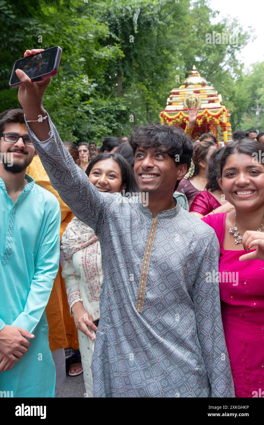 A happy young man takes a selfie of himself, his lady companion and the ...