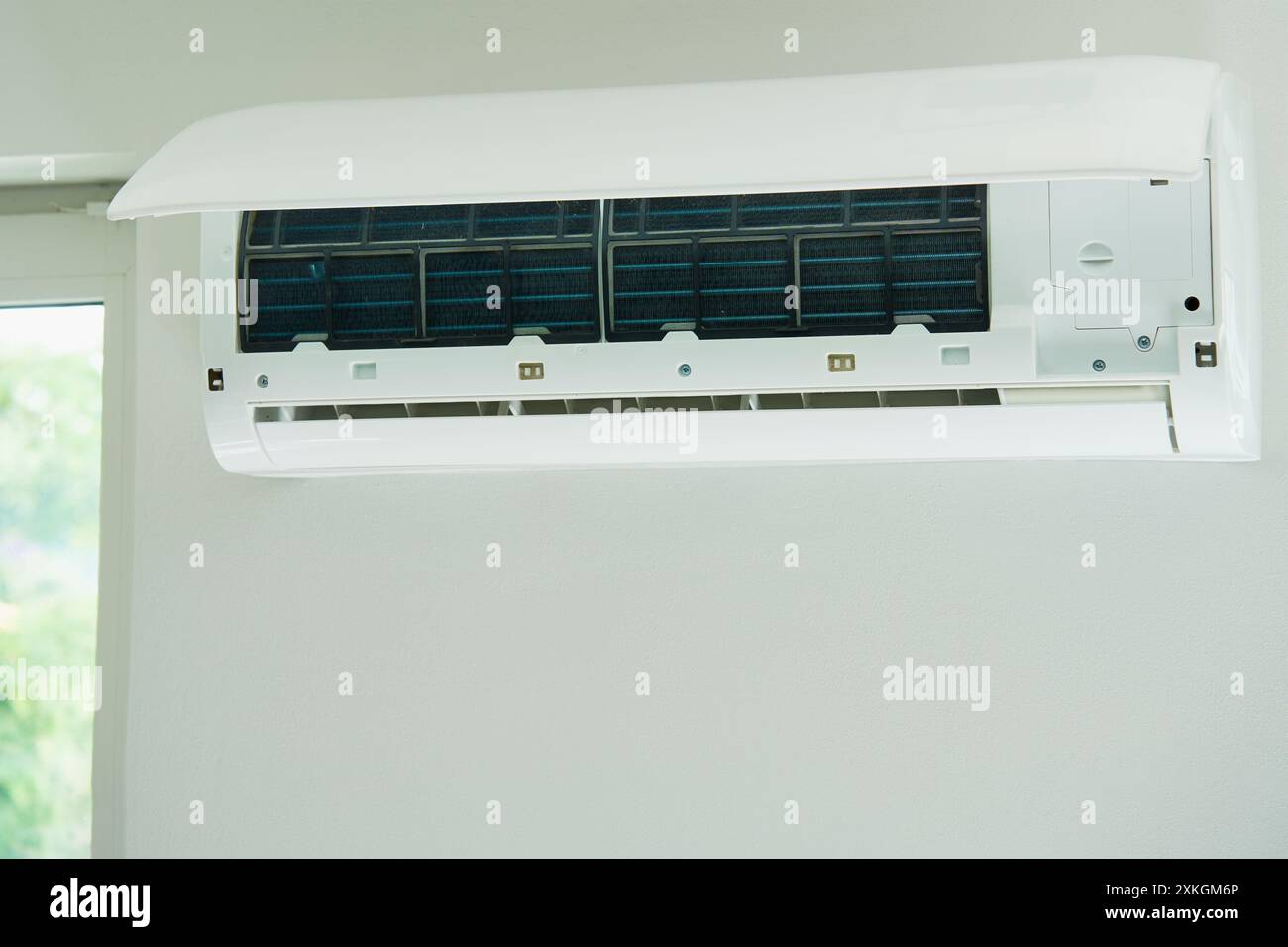 White air conditioner unit is mounted on wall, ready for maintenance ...