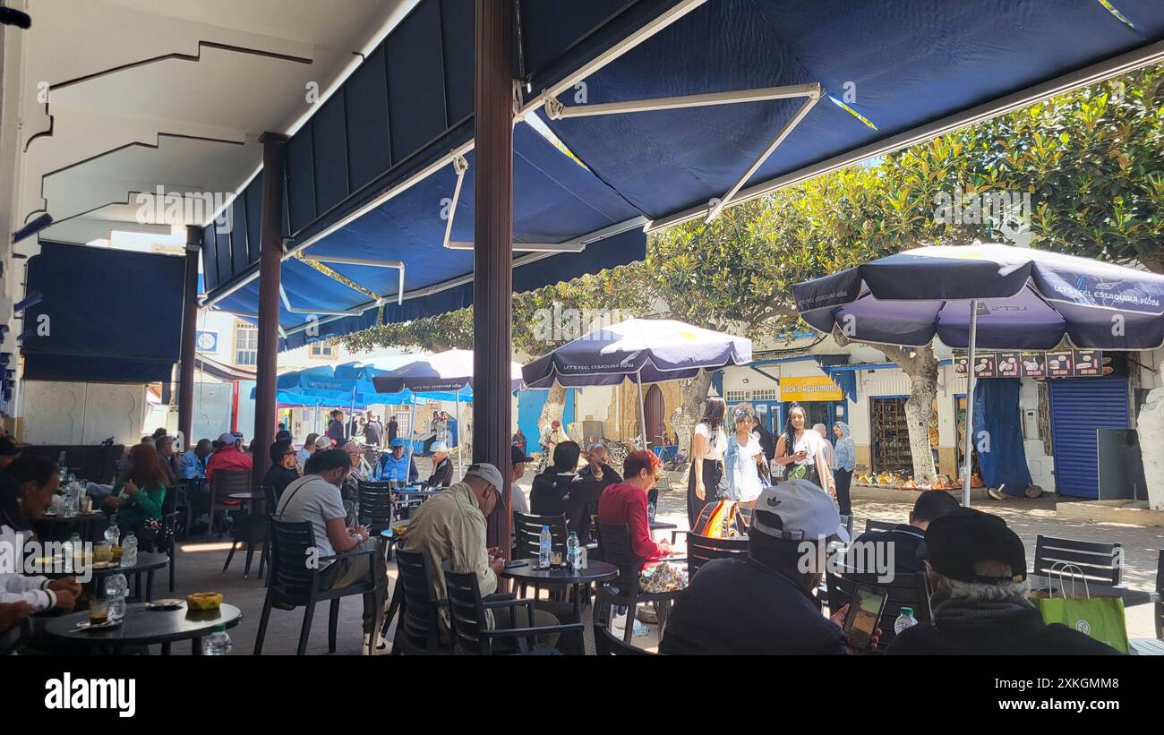 People sitting on the terrace of a cafe in the Medina of Essaouira ...