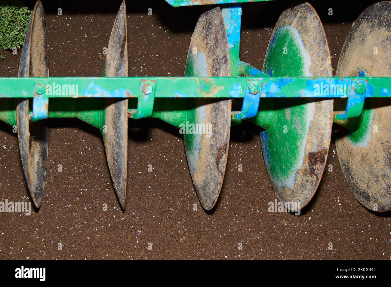 Detailed shot of soil-covered plough discs showcasing agricultural work ...