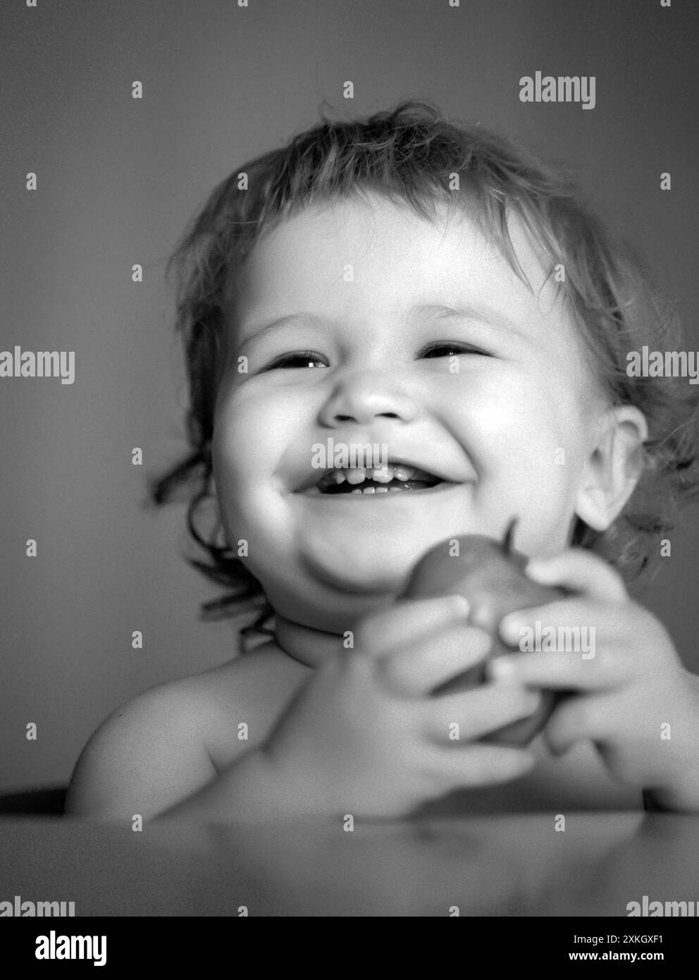 Funny smiling kid eating apple Black and White Stock Photos & Images ...