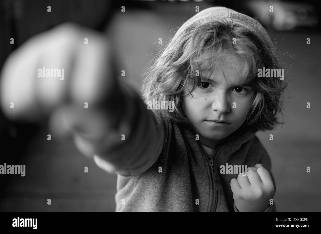 Aggressive bad child. Kid boy in hoodie fighting. Little kid boy fight ...