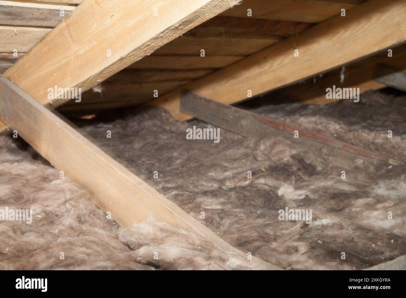Construction worker mineral wool thermally insulating house attic with ...