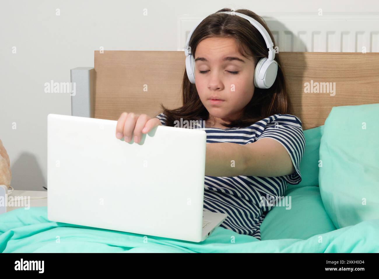 Girl is tired of the computer and going to sleep Stock Photo - Alamy