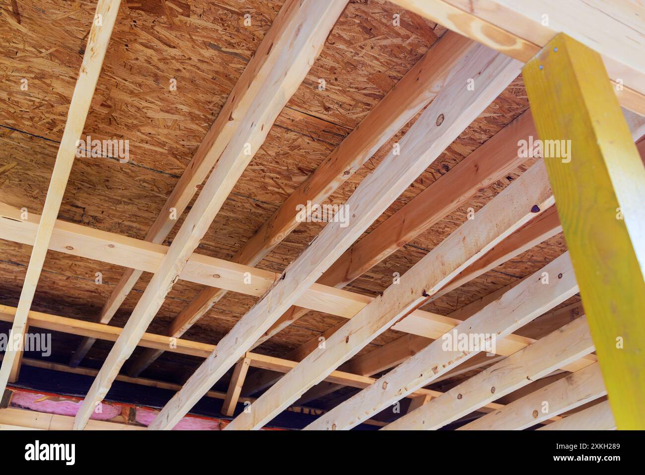 Wooden frame beams are used to frame roofing trusses when building new ...