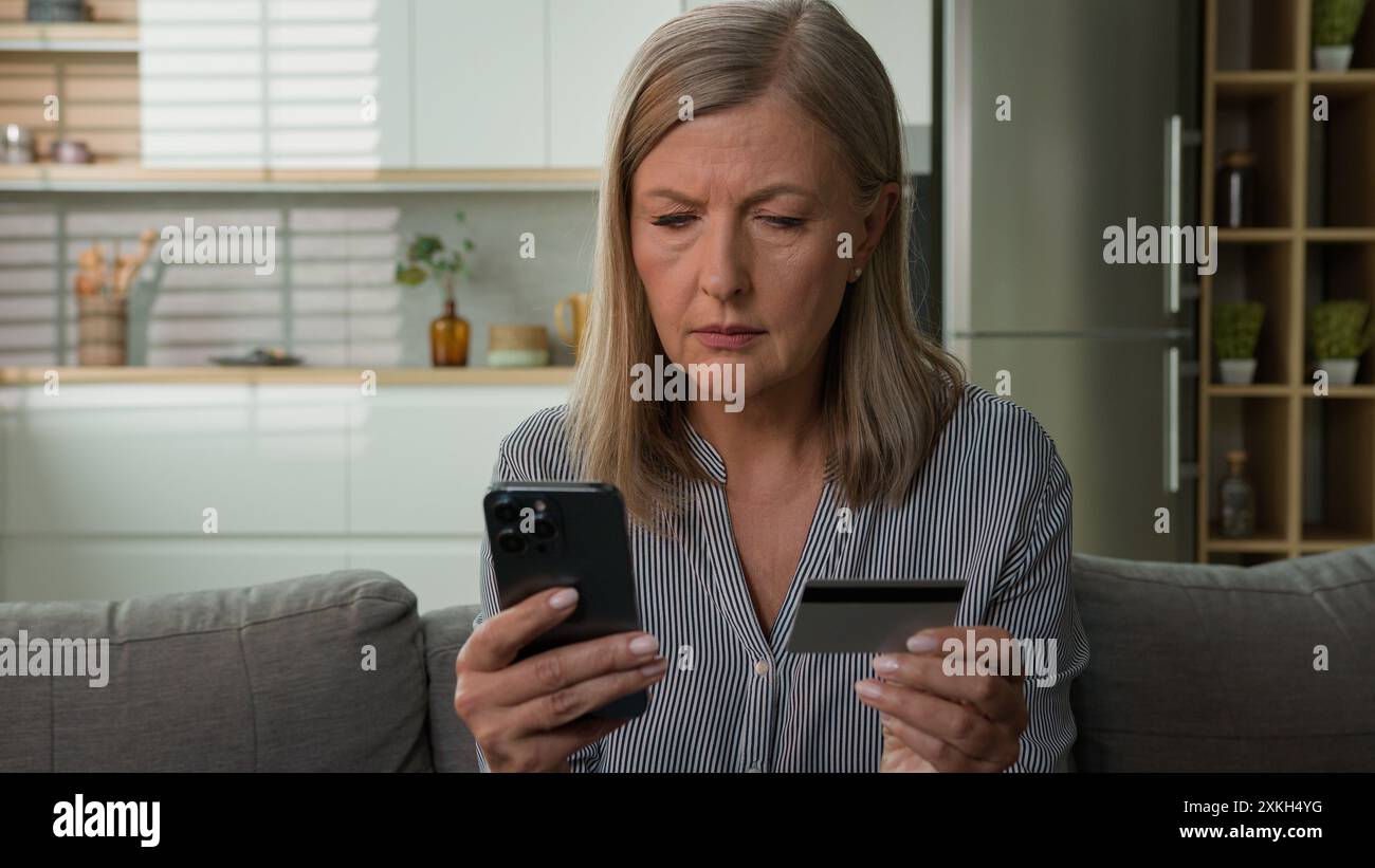 Confused frustrated mature Caucasian elderly woman female banking app ...