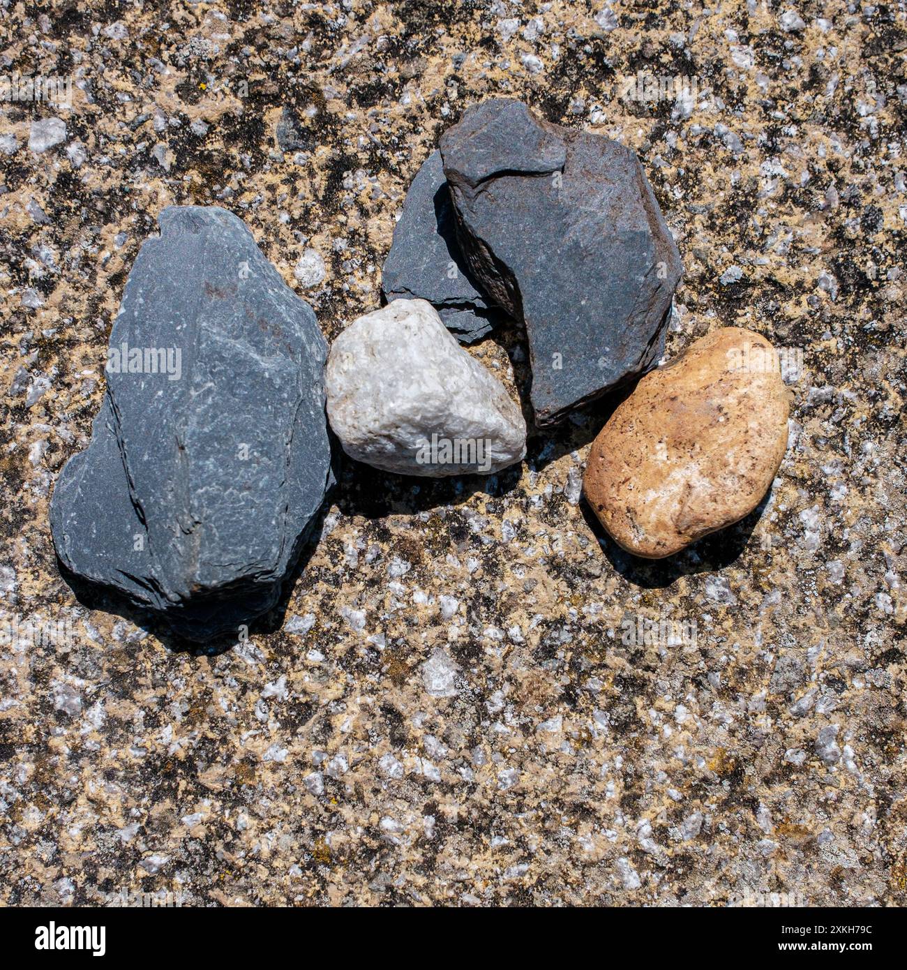Four stones on a concrete slab - 2 of which are slate Stock Photo - Alamy