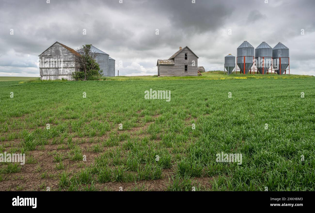 Grain Bins and Old Abandoned House on the Horizon near the village of ...