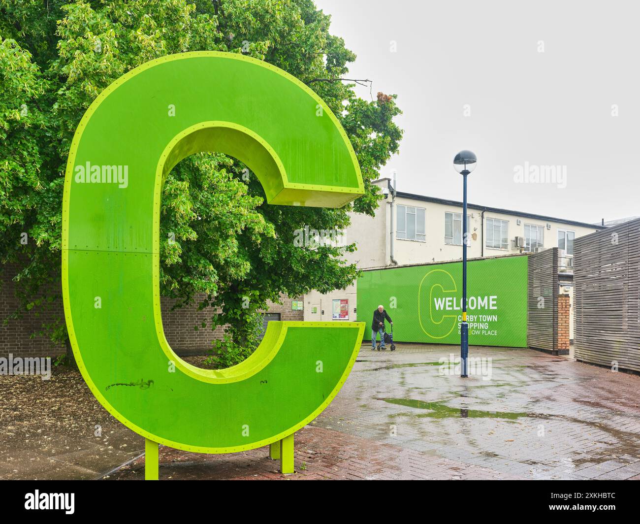 Entrance, on a rainy day, to Corby town centre shopping complex and ...