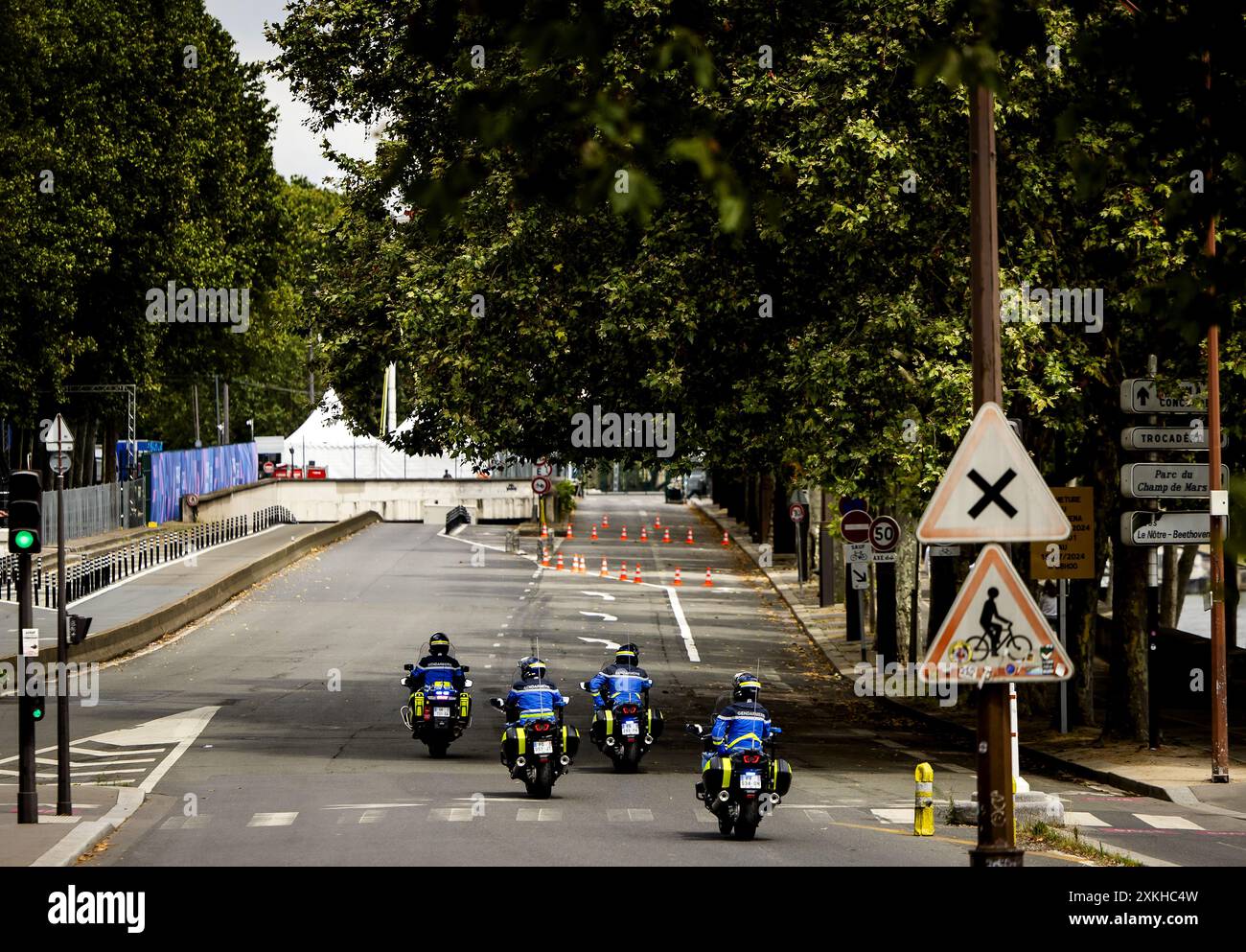 PARIS - Police motorcycles ride through closed streets along the Seine ...