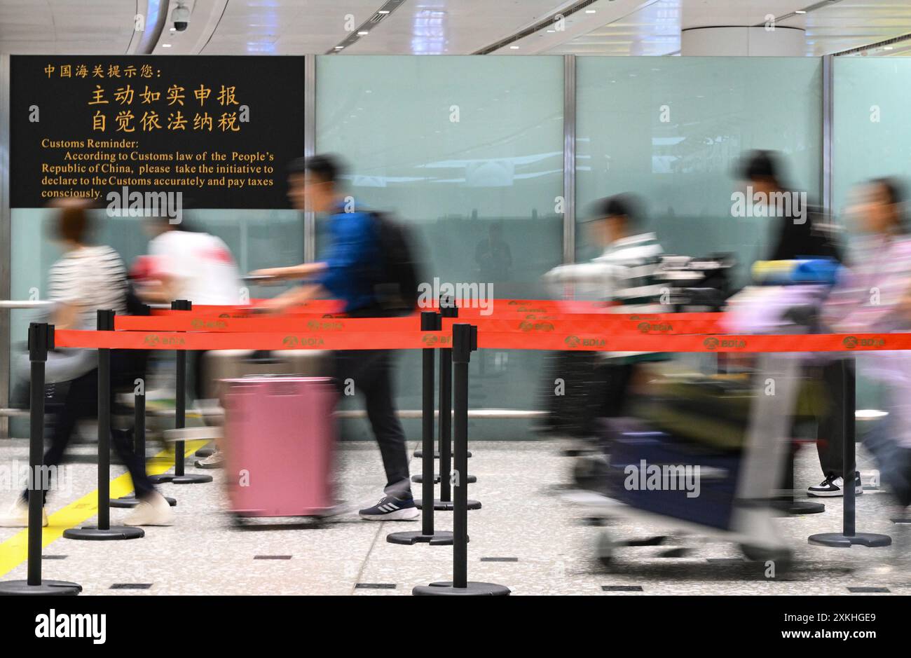 Beijing, China. 18th July, 2024. Travelers pass through customs at ...