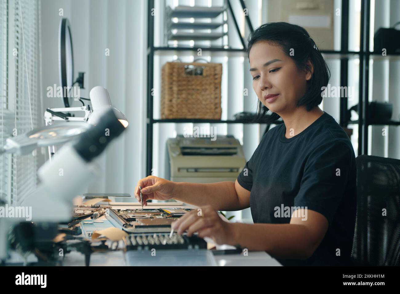 Woman disassembling computer motherboard hi-res stock photography and ...