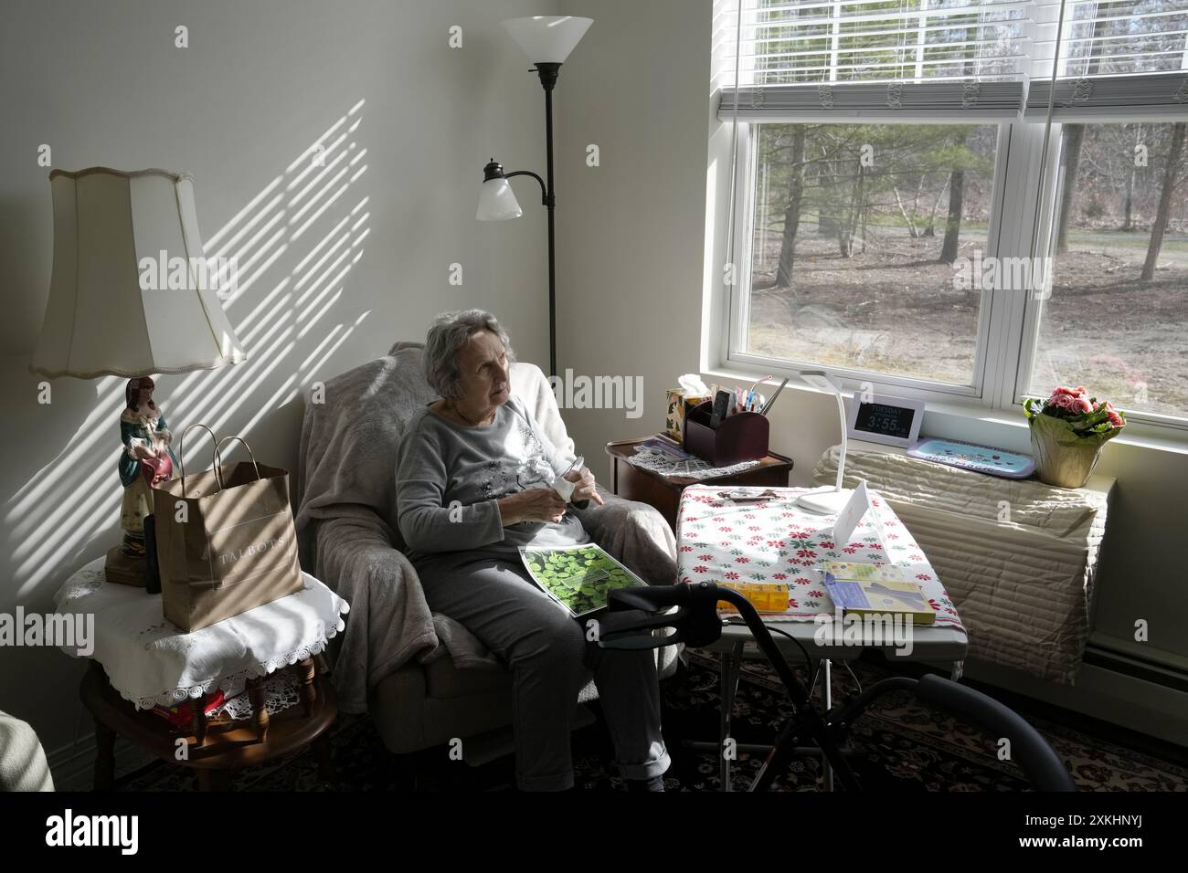 A 95 year-old woman in her apartment in an assisted living facility ...