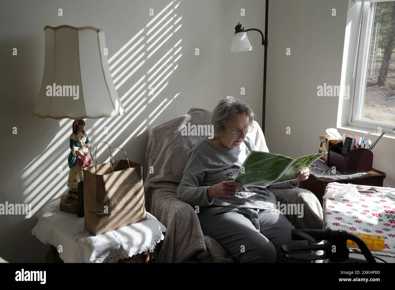 A 95 year-old woman in her apartment in an assisted living facility ...