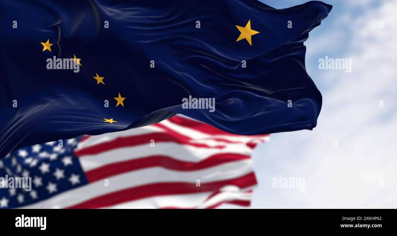 Alaska state flag waving in the wind with the national flag of the ...