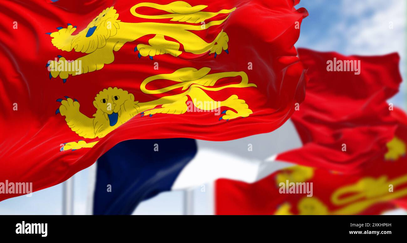 Flags of Normandy and France waving in the wind on a clear day ...