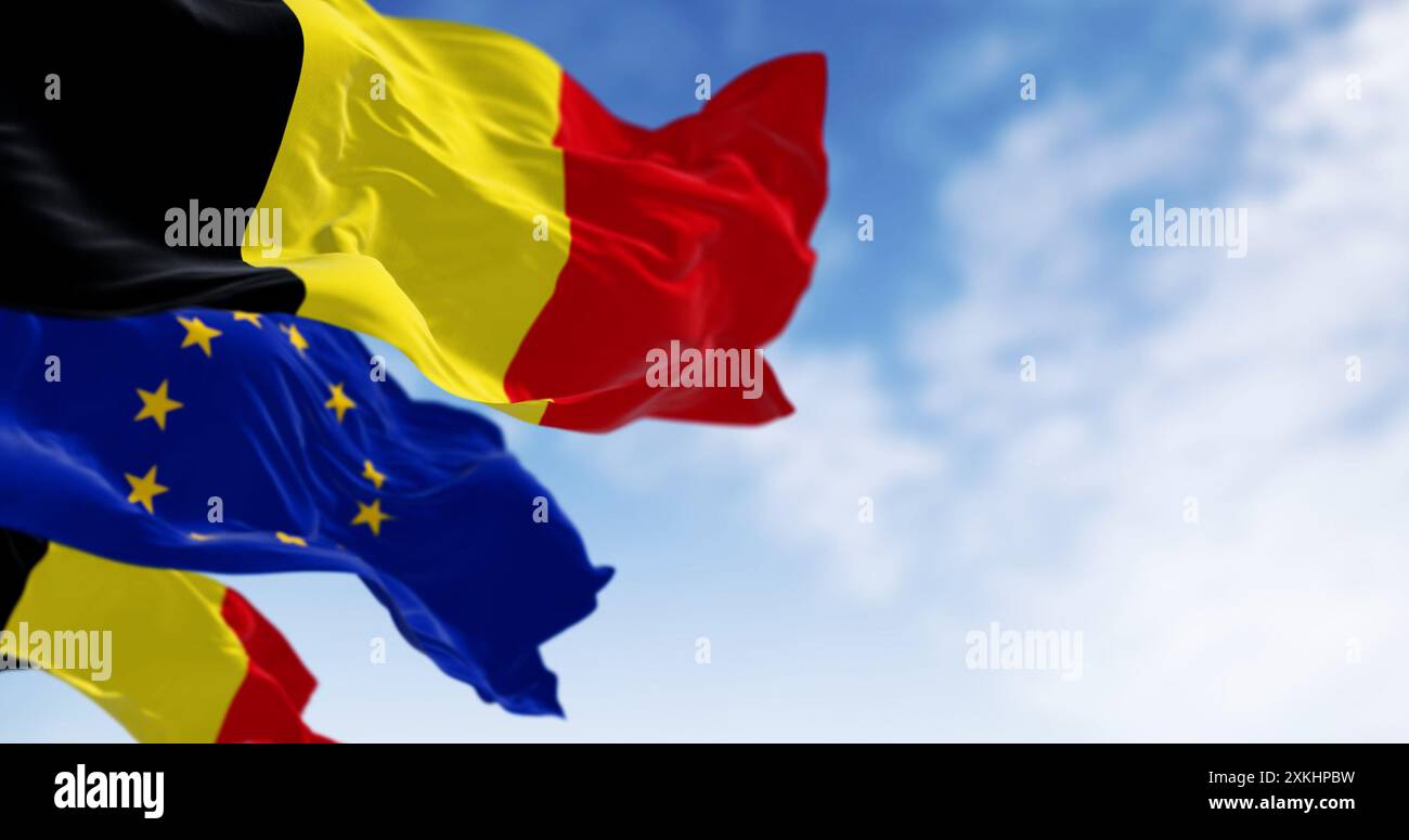 Belgium and European Union flags waving together on a clear day ...
