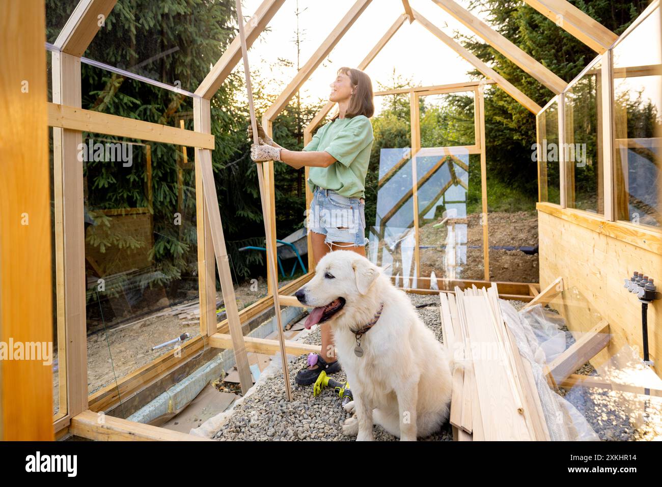 Female Carpenter with Her Dog in Greenhouse Stock Photo - Alamy