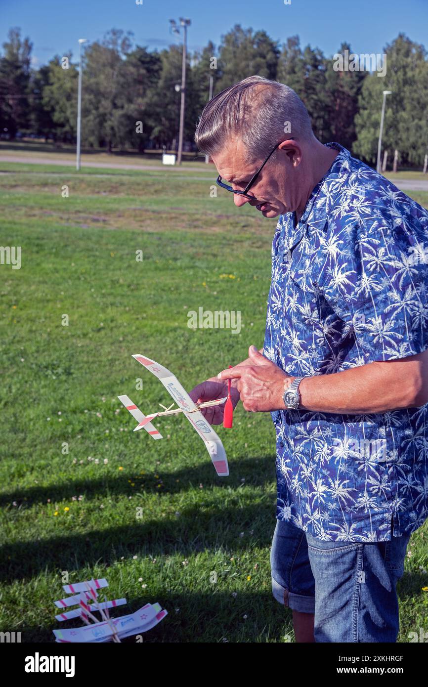 Adults have fun with rubber band-powered small gliders Stock Photo - Alamy