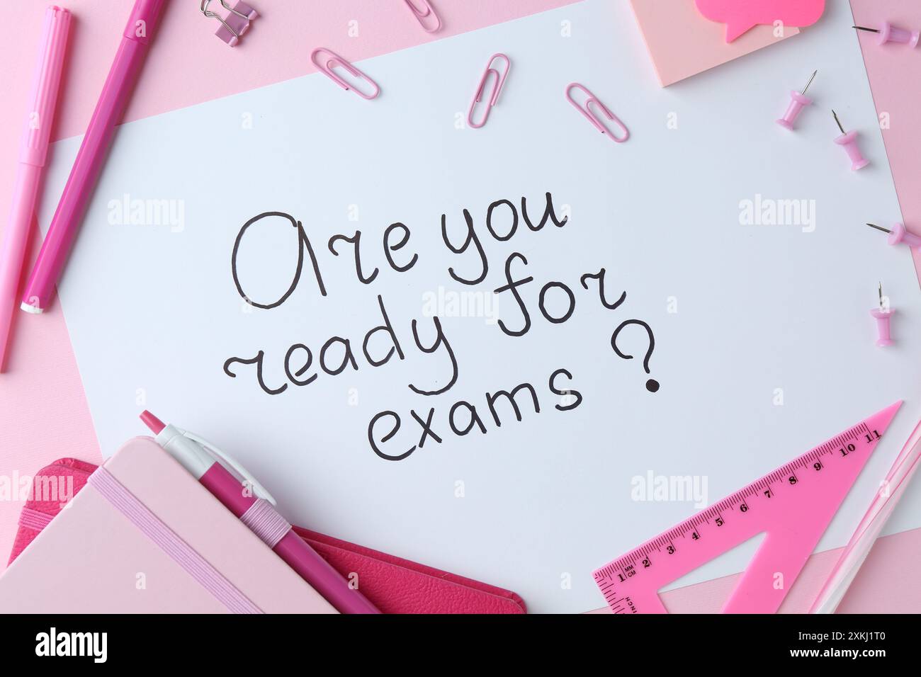 Paper note with question Are You Ready For Exams and stationery on pink ...