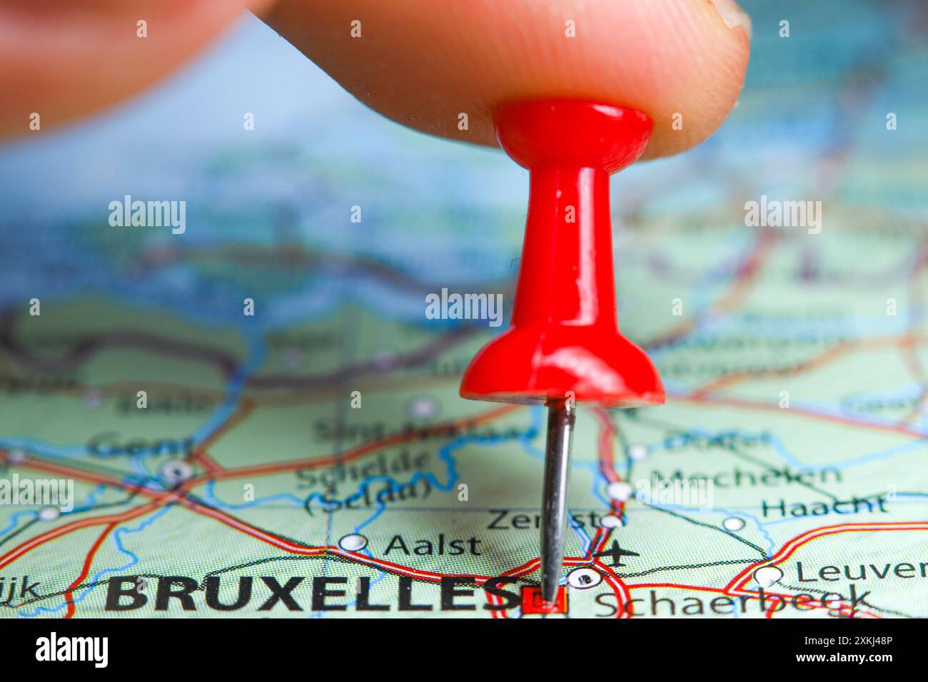 Hand pinning Bruxelles, Belgium on a map Stock Photo - Alamy