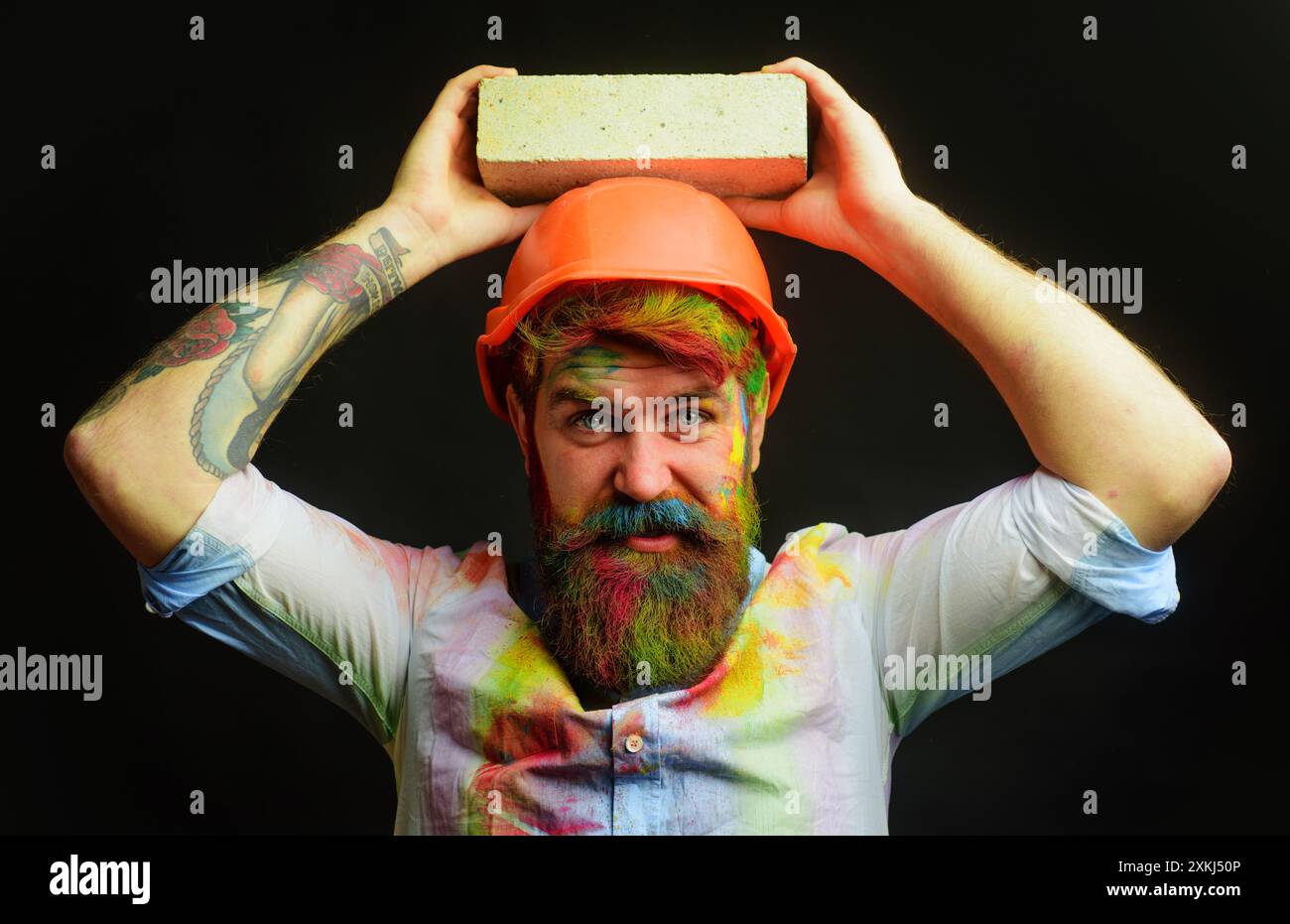 Mason bricklayer with brick. Man builder bricklayer in orange hard hat ...