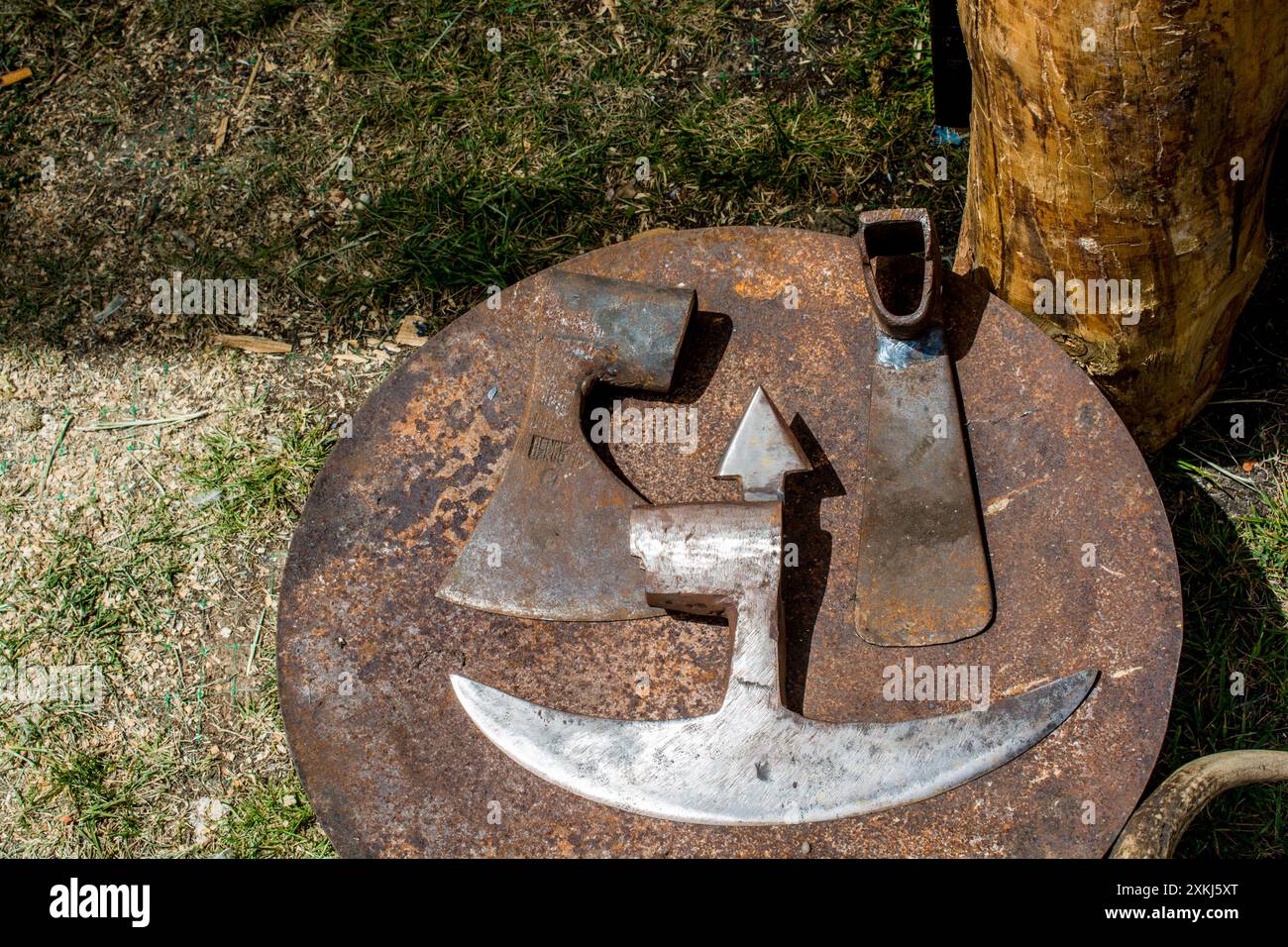 3 rusty steel axe heads in the view Stock Photo - Alamy
