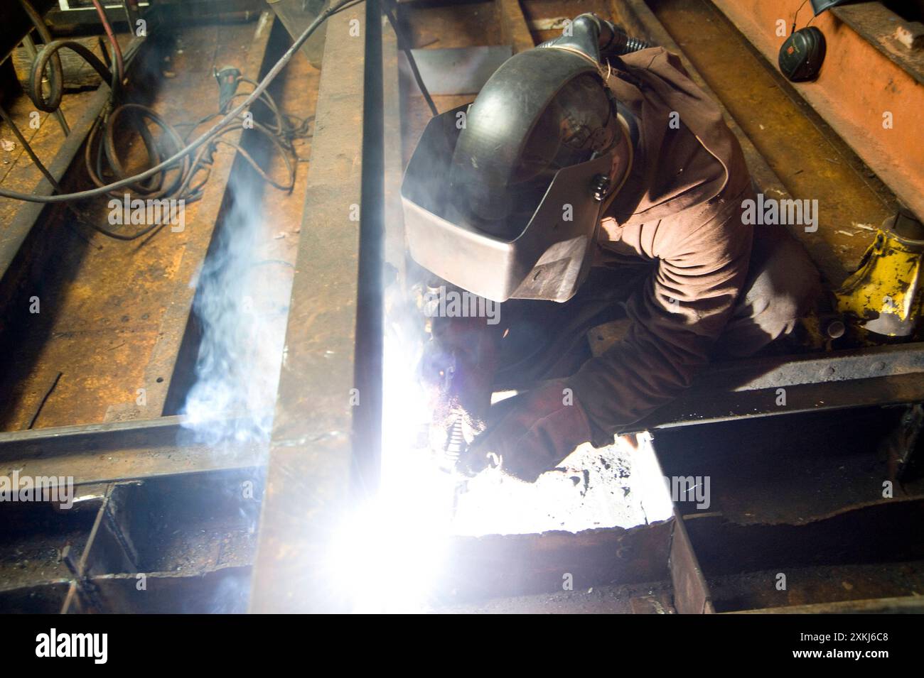 Portrait Ship s Welder Ship s Welder working on the interior hull of a ...